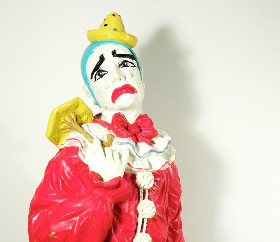 large vintage clown statue . sad . parasol and stars