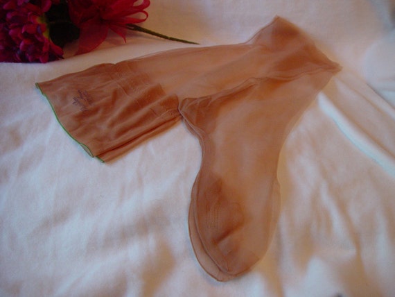 Vintage seamed nylon stockings with keyhole welt opening at