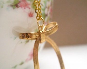 Gold ribbon necklace | Etsy