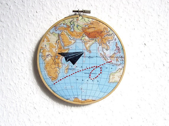 Aviator on world tour // Paper aviator on a world map with
