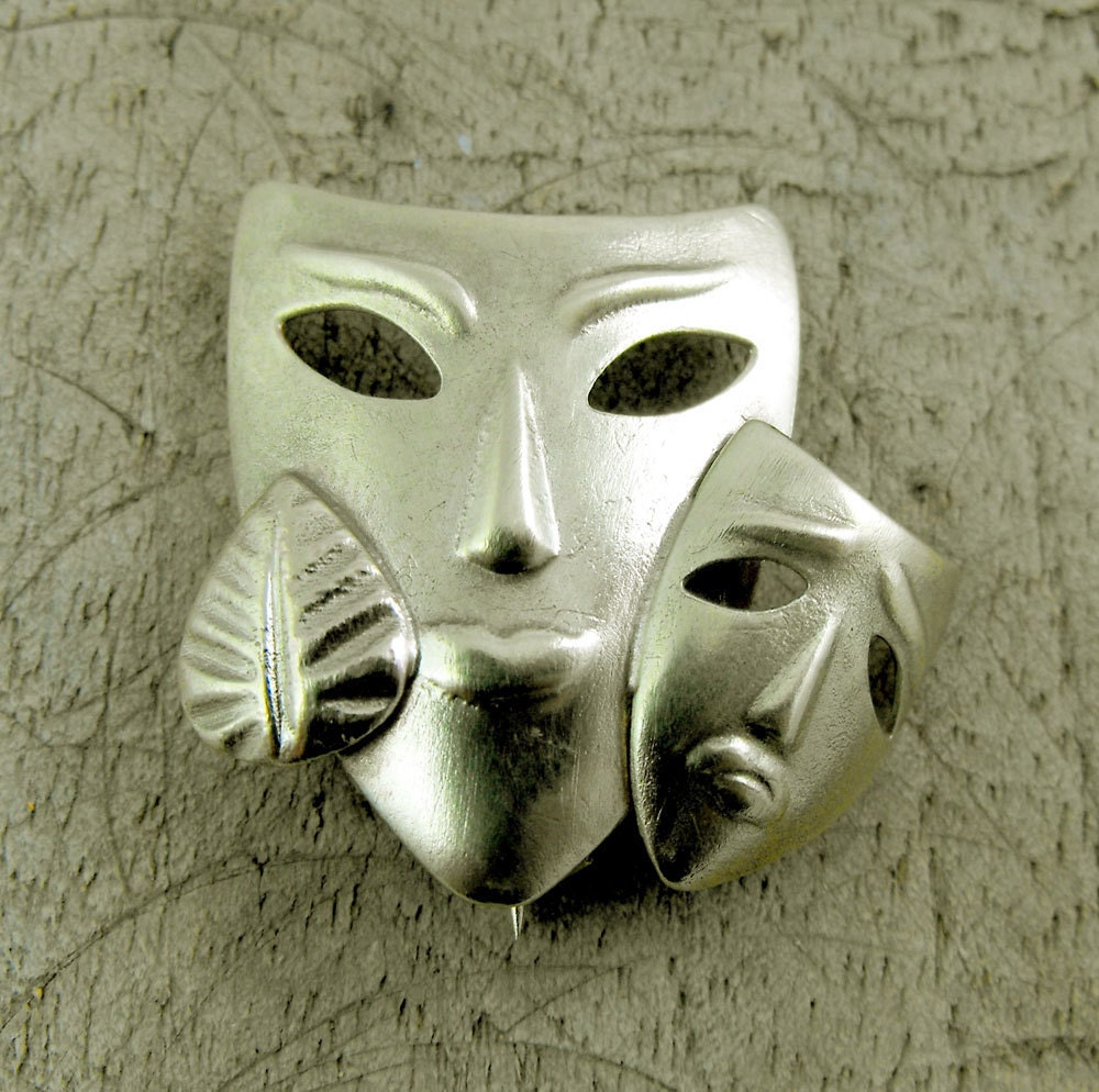 Happy and sad theater masks. Vintage brooch in shiny by pearage