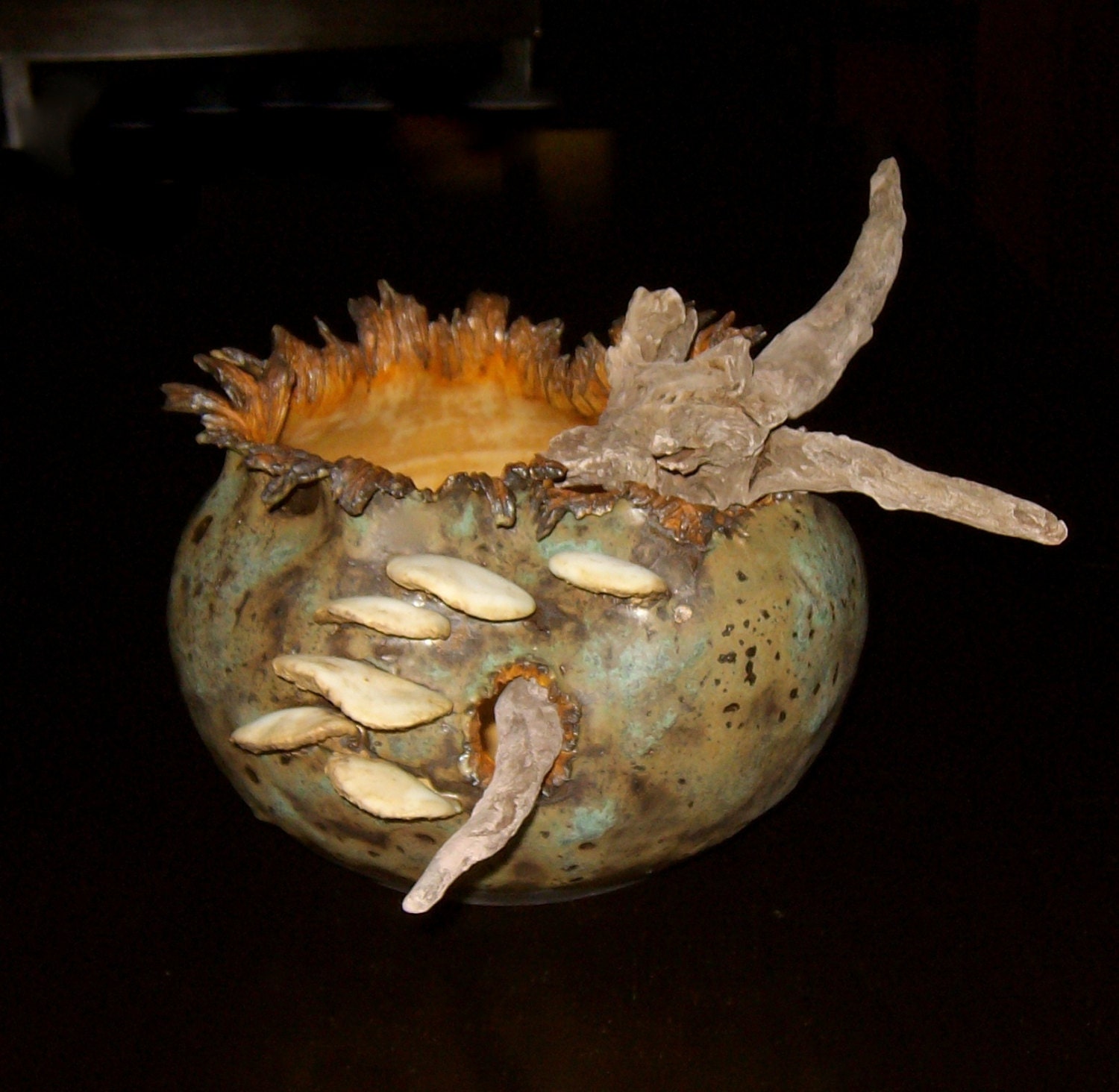 Sculptural abstract pottery earth pod with driftwood and
