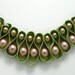 Light green ribbon looped pearl necklace. Gold pearls and