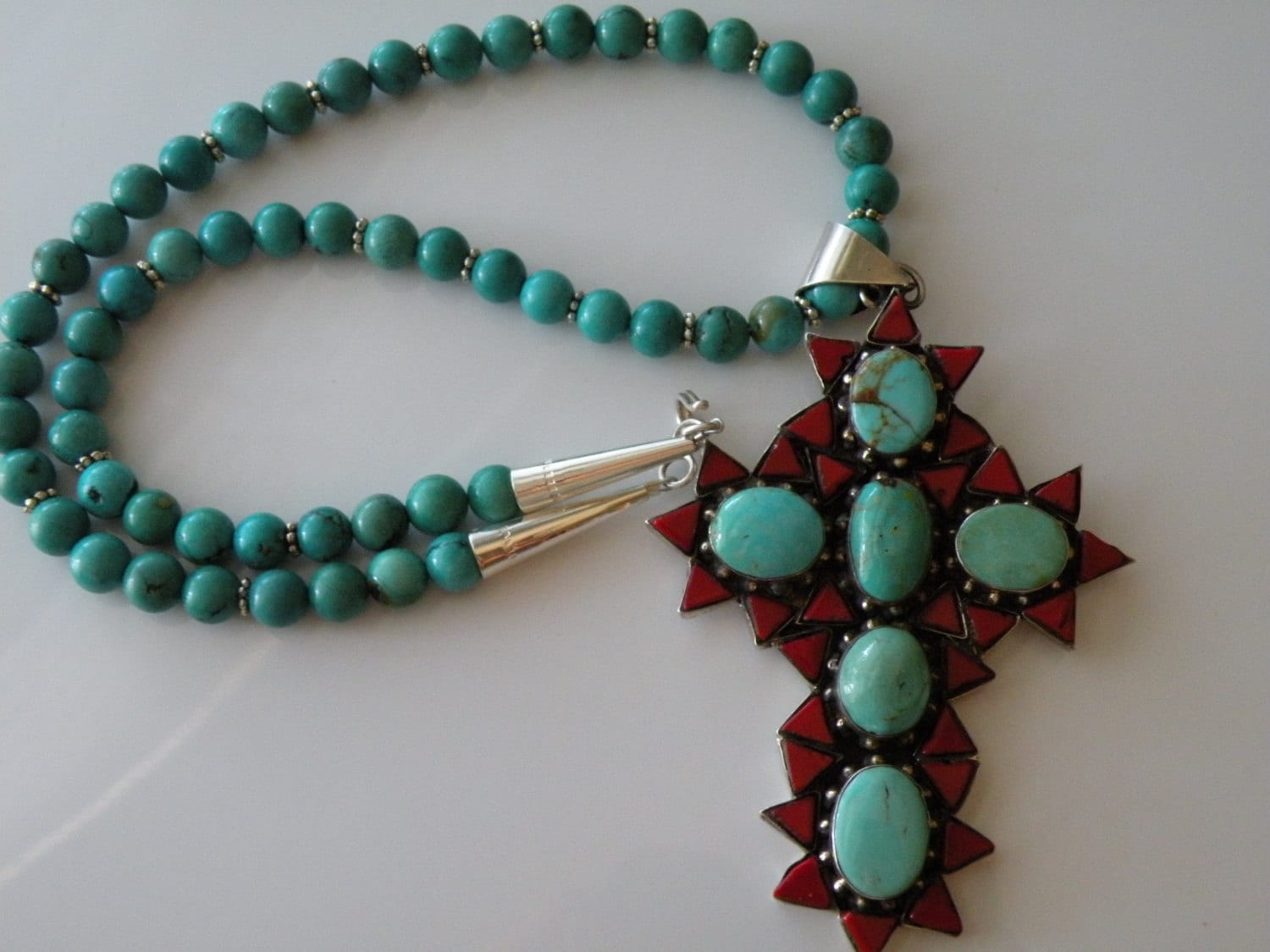 Sterling silver turquoise cross pendant on turquoise beads