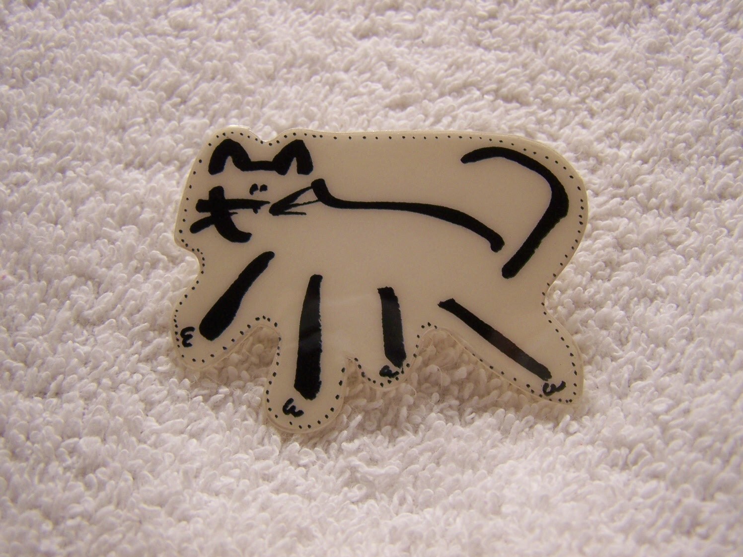 Calligraphy sketched cat is cut out of art paper and