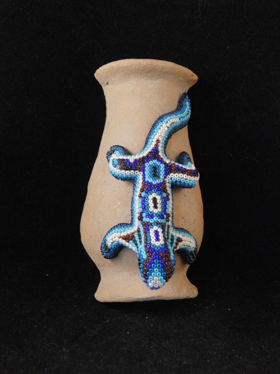 Handcrafted clay pot with lizard.