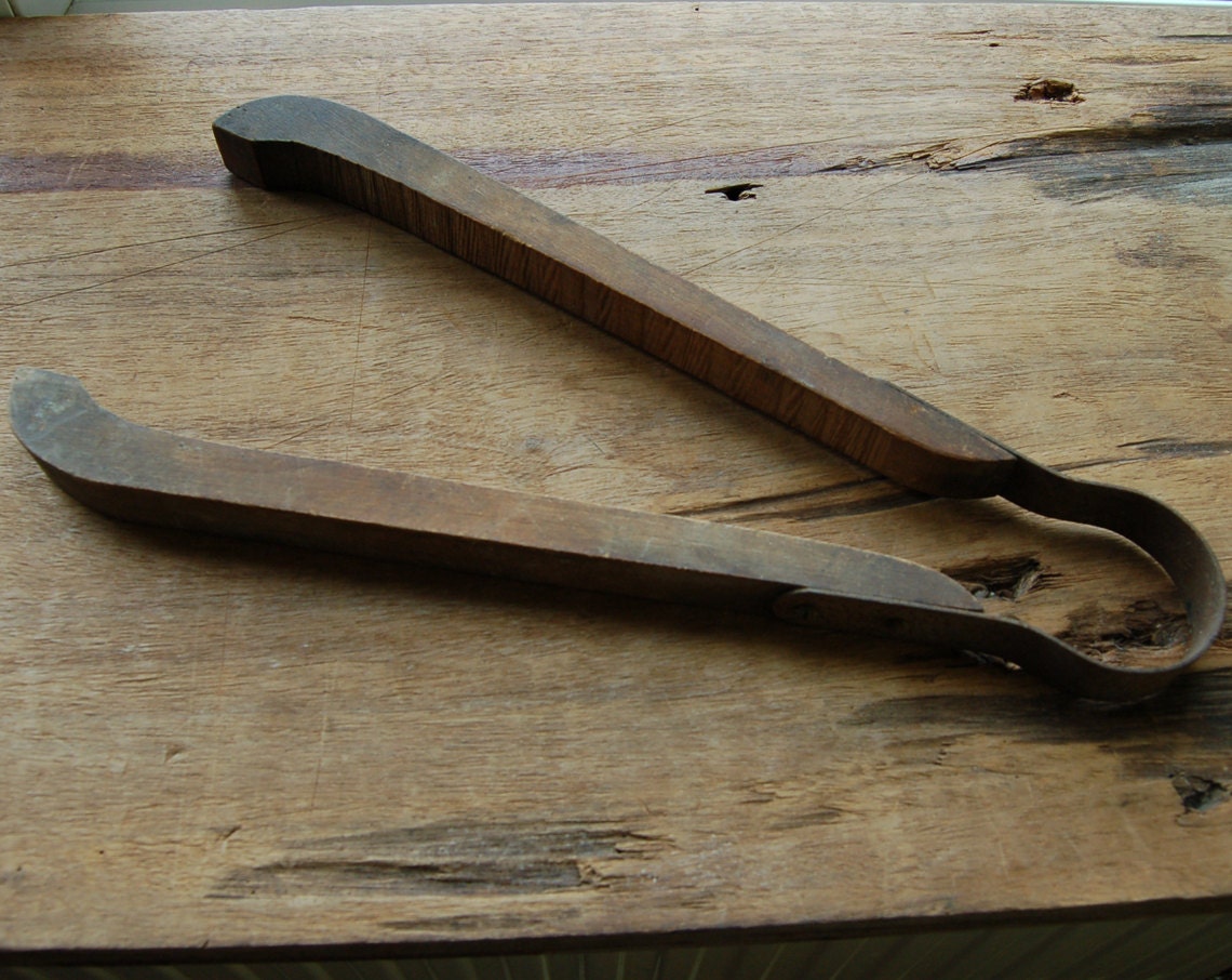 Vintage pair of rustic wood and metal washing tongs laundry