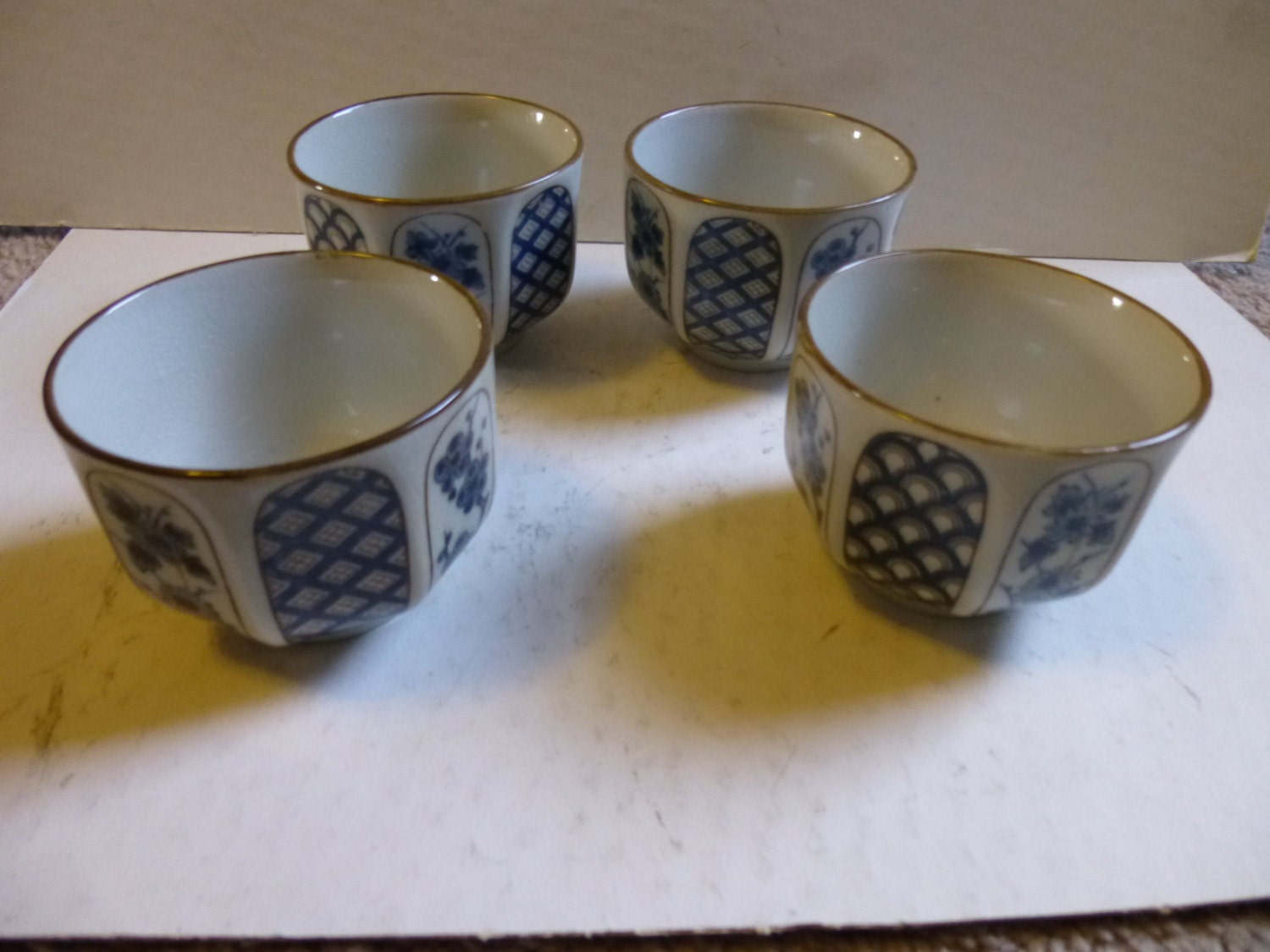 Set of 4 lovely handleless tea cups with alternating floral and trellis ...