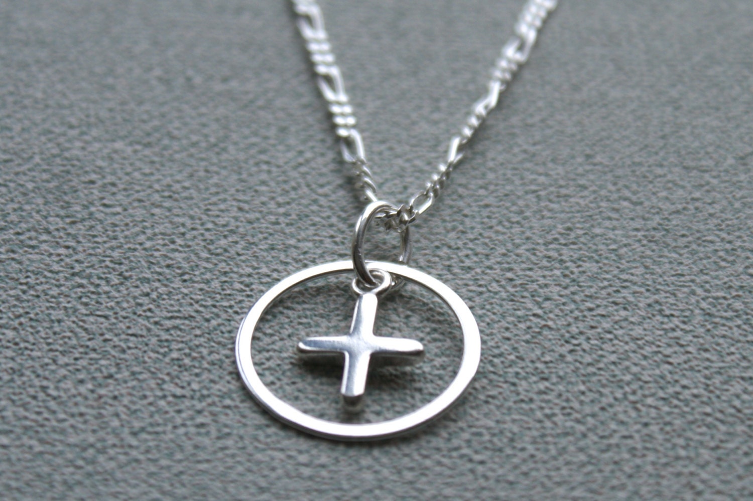 Cross inside a circle. Pendant for submissive or slave female