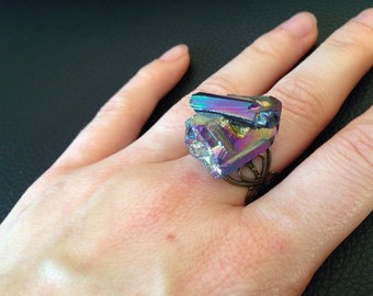 Brass filigree ring featuring titanium rainbow quartz crystal point