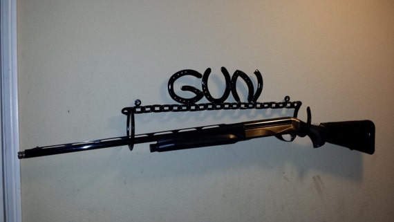 Items similar to Horseshoe and chain gun rack on Etsy