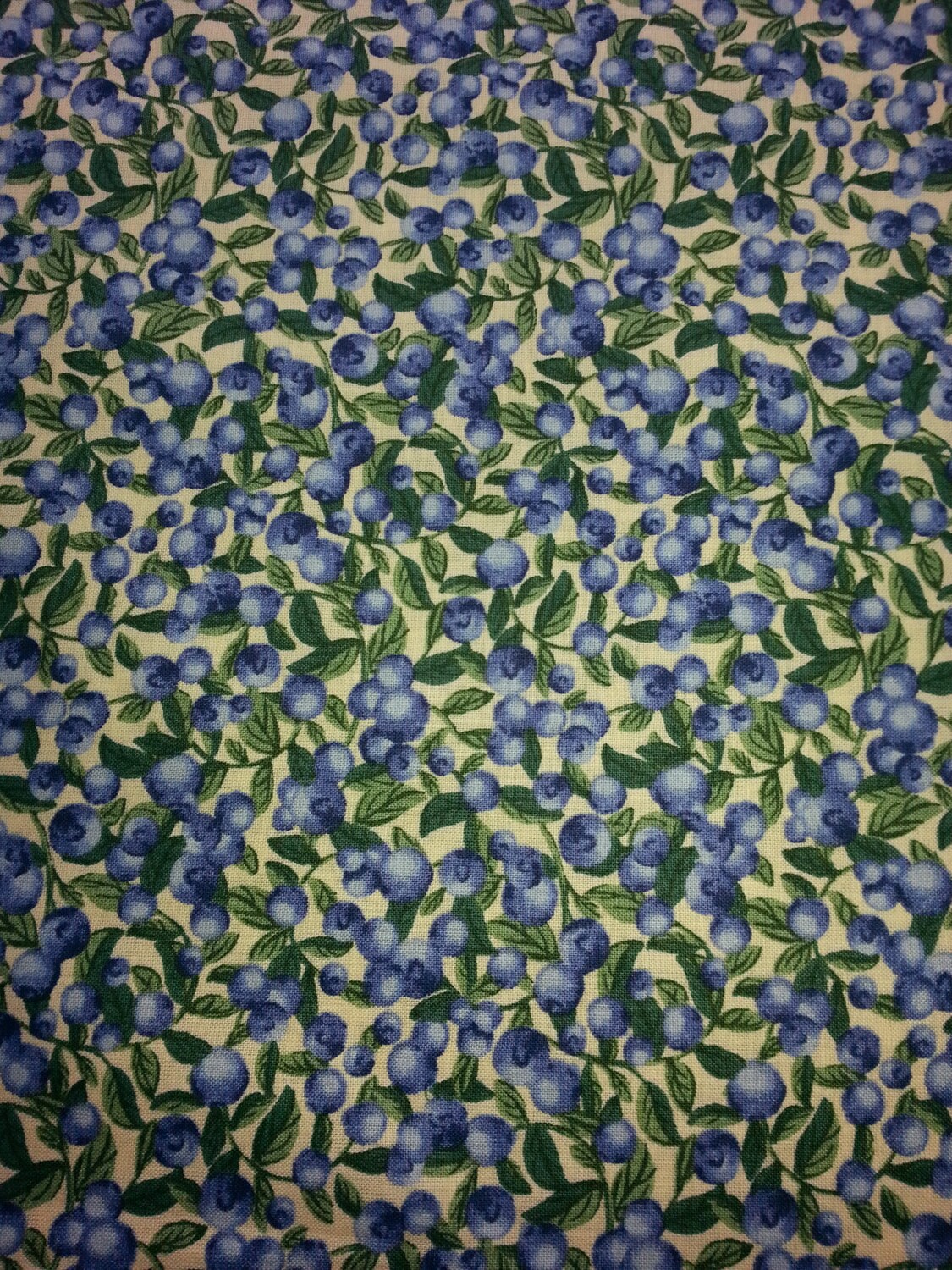 Blueberry print fabric on a cream background.