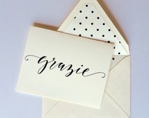 Hand lettered "Grazie" thank-you card with soft-white polka dot lined ...