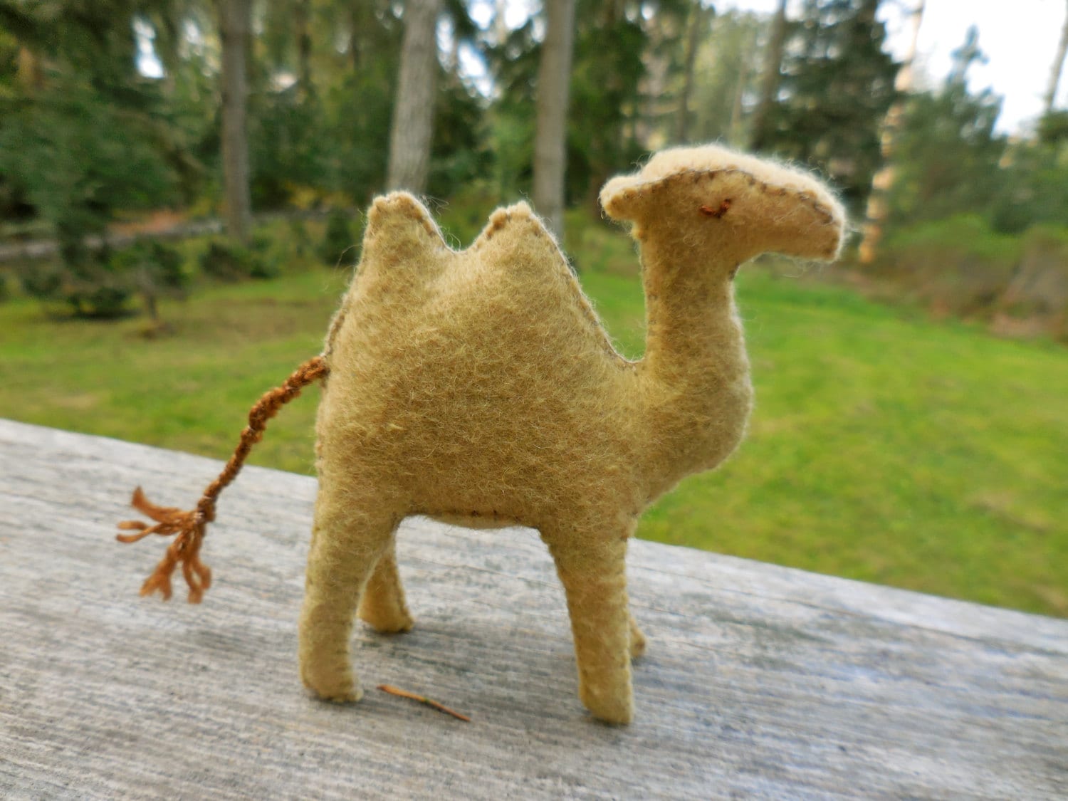 Small stuffed tan colored camel handsewn by WoolStreetStitchery