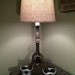 Hand crafted table lamp using repurposed engine/car parts.