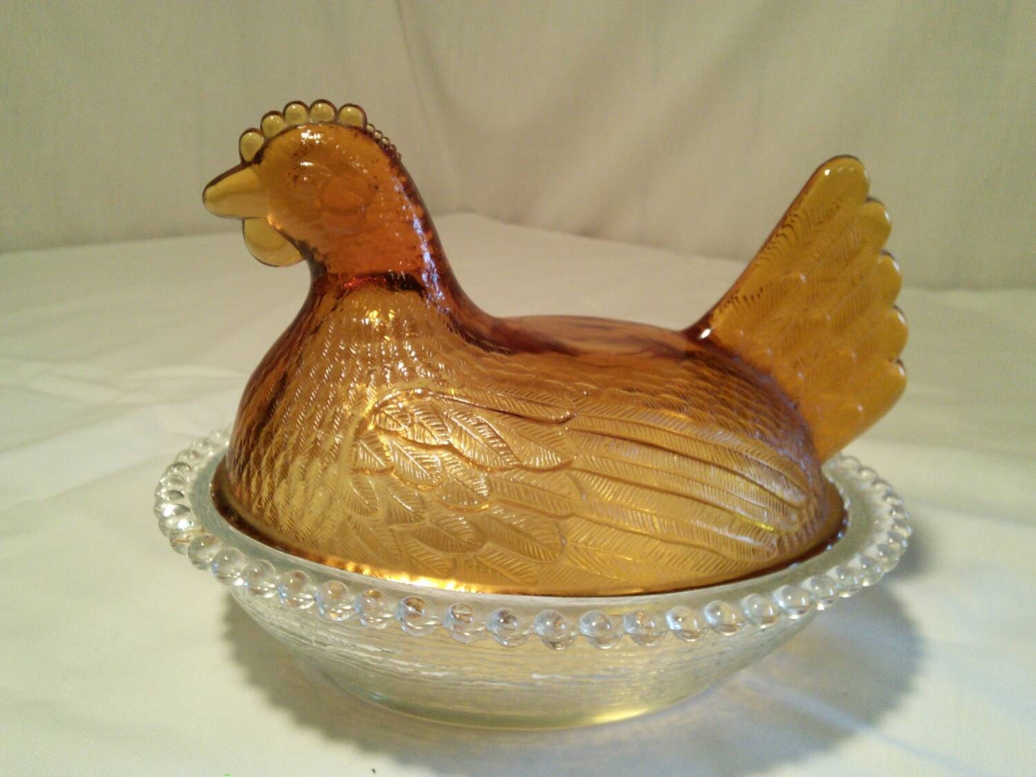 Hen on Nest Indiana Glass Amber Chicken on clear glass nest