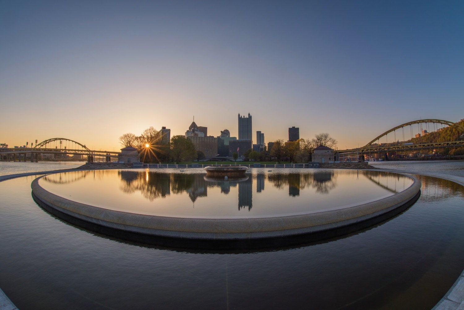 Pittsburgh reflects in the fountain at Point State Park at