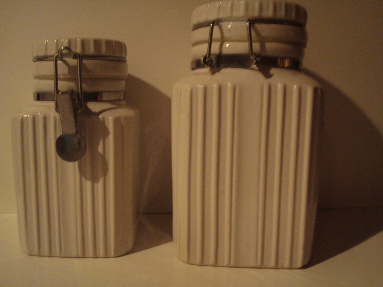 Two white locking canisters – Haute Juice