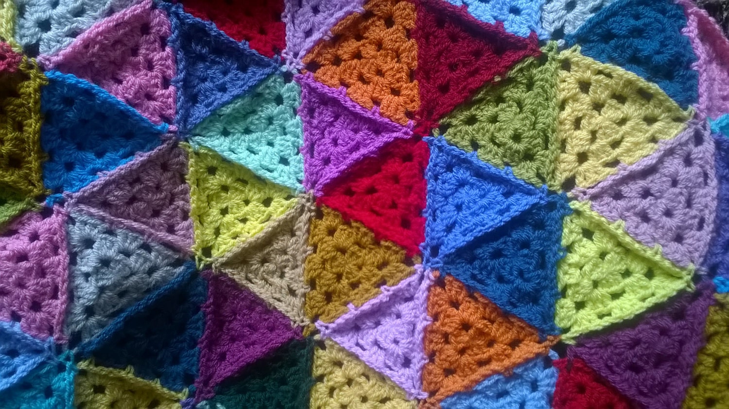 Crocheted granny triangle blanket