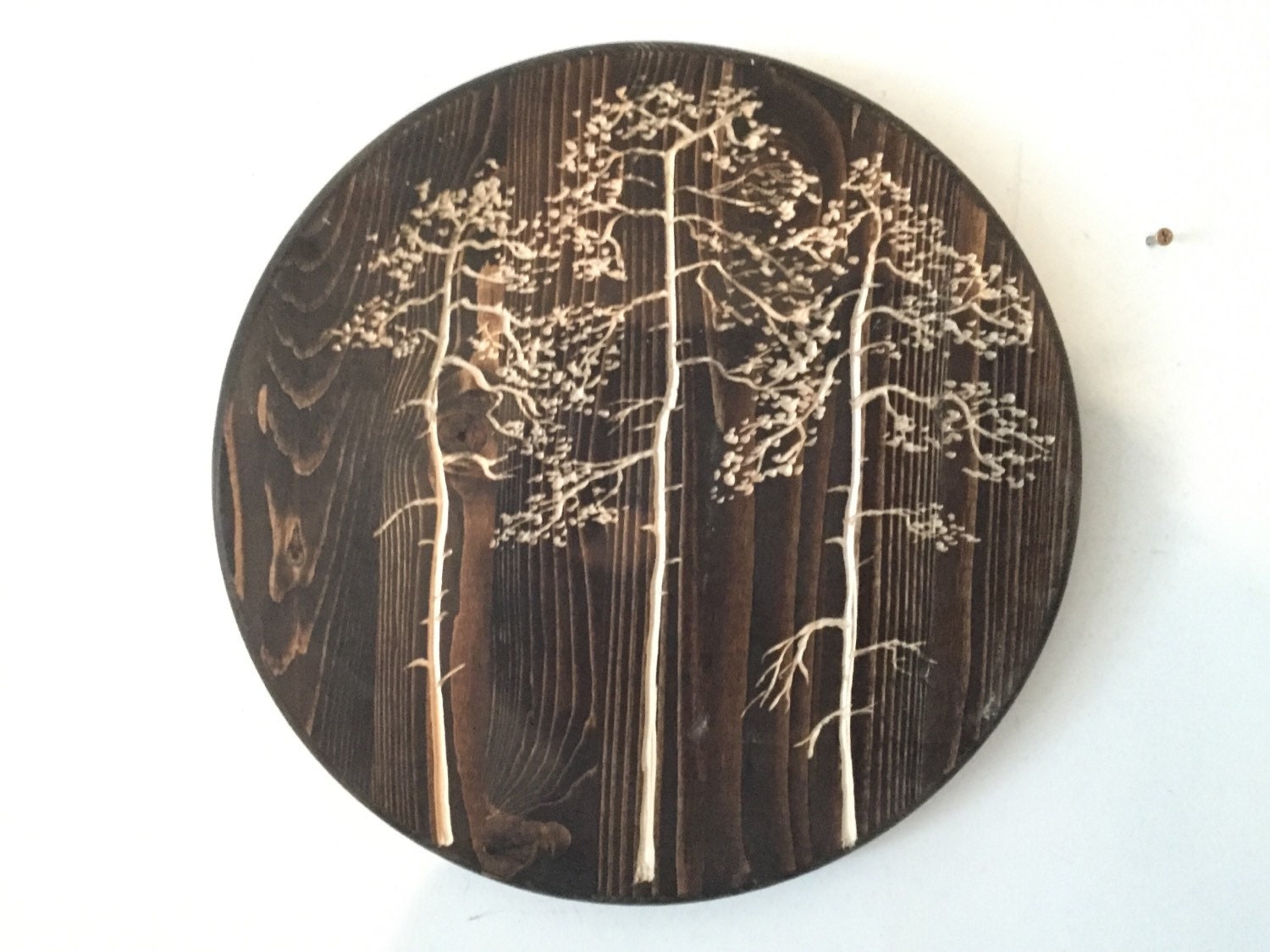 Round wood carved 15 across pine trees with dark walnut