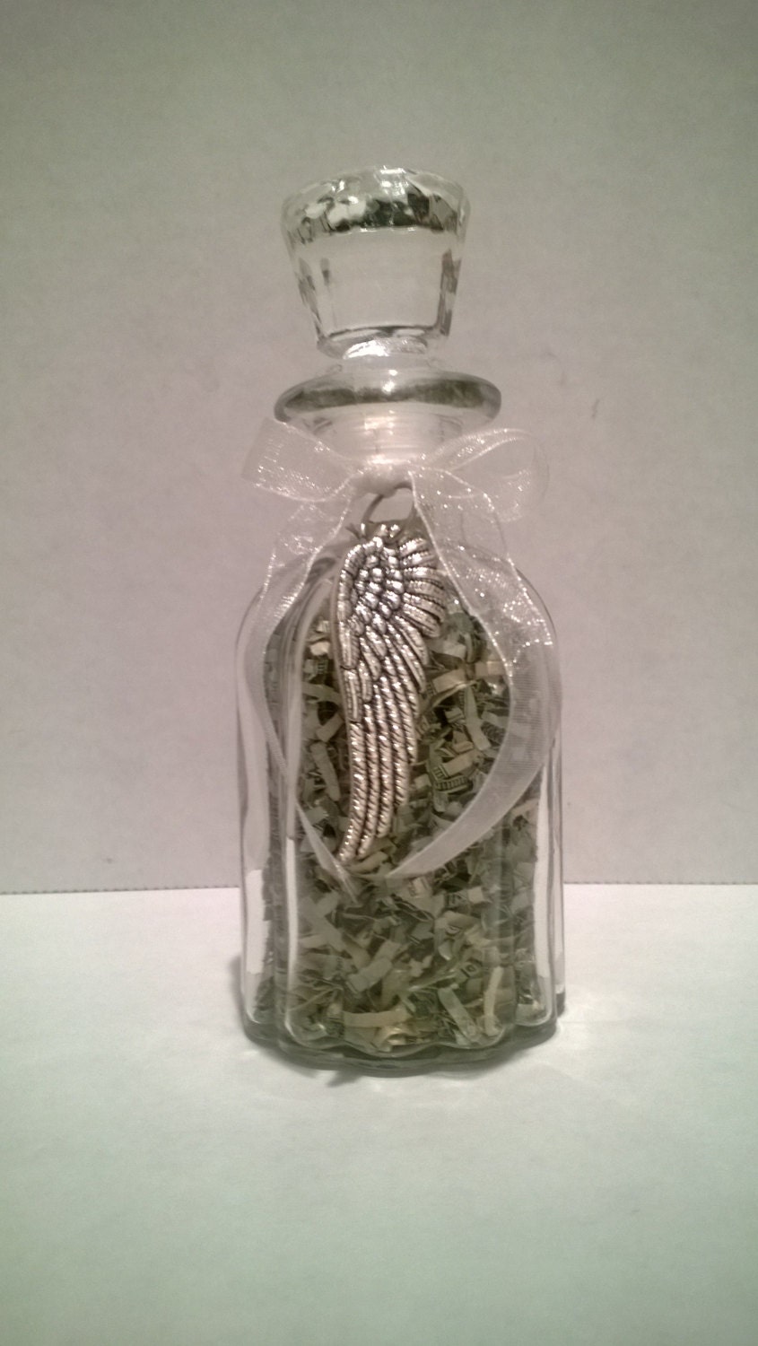 Beautiful Money filled Angel Wing bottle. Filled with shredded