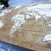 World map with wood burned outlines on one piece