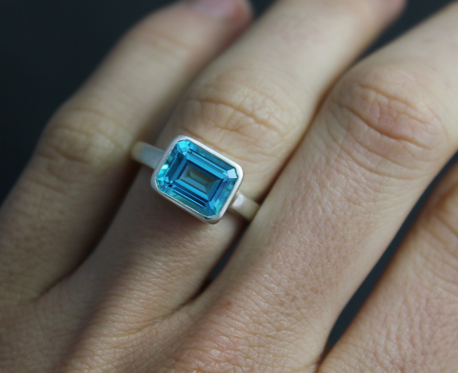 Emerald Cut Blue Topaz Ring East to West Ring Bezel Set