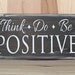 Think positive wood sign with saying inspirational quote