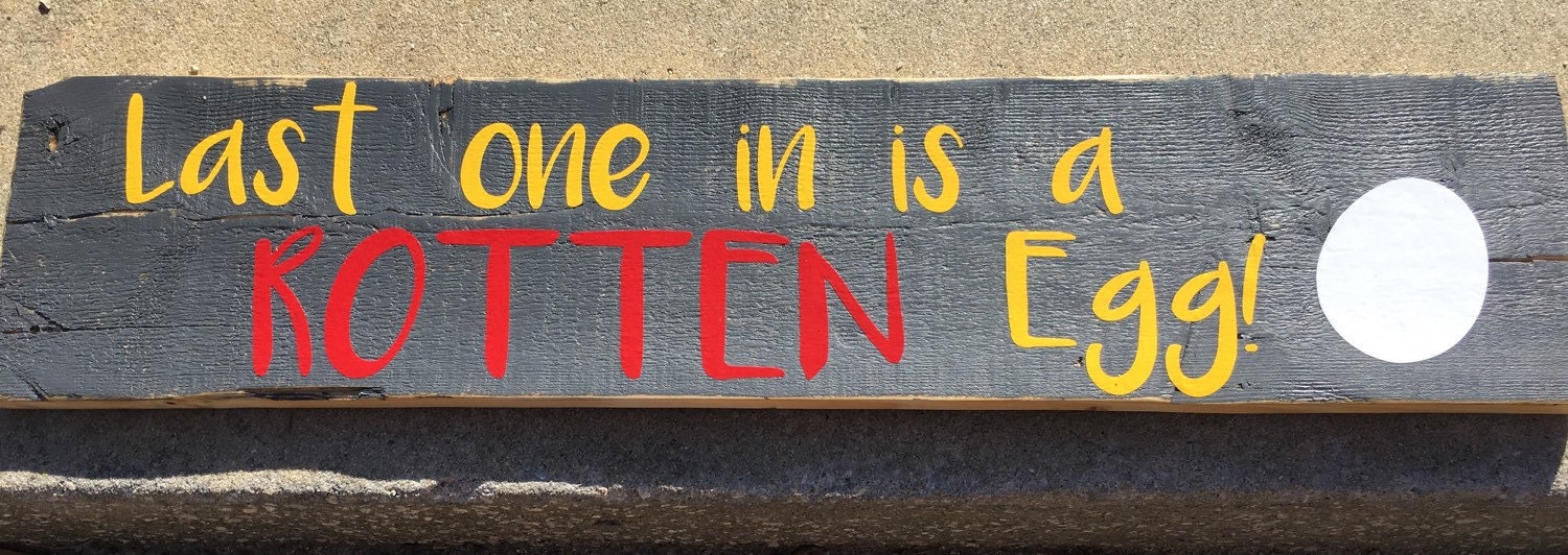 Chicken coop sign. Last one in is a rotten egg.