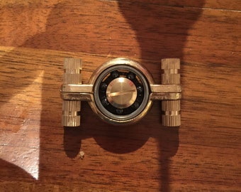 Hand made fidget toy. Brass hand spinner with neon glow sticks