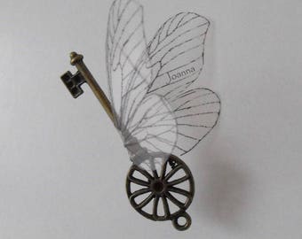 Magical flying key with large butterfly wings in shiny silver