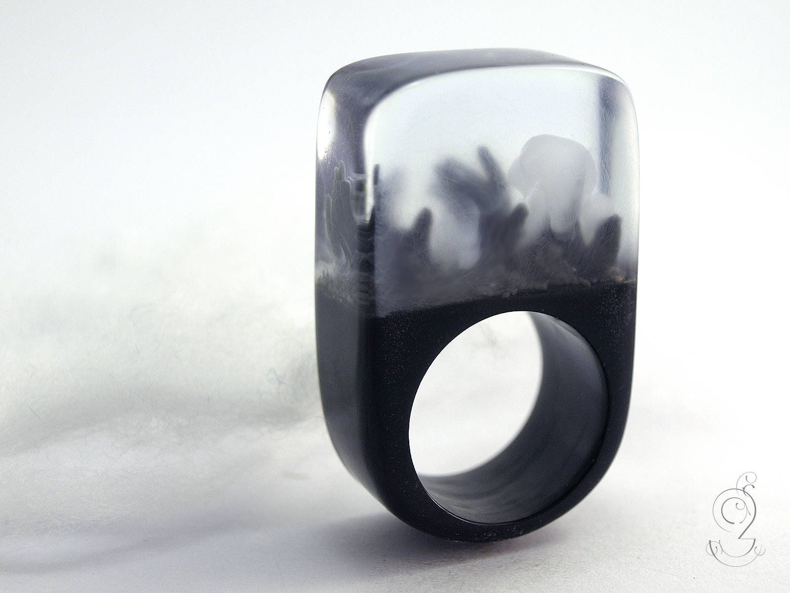 Zombie creepy undead ring with three black hands and fog on