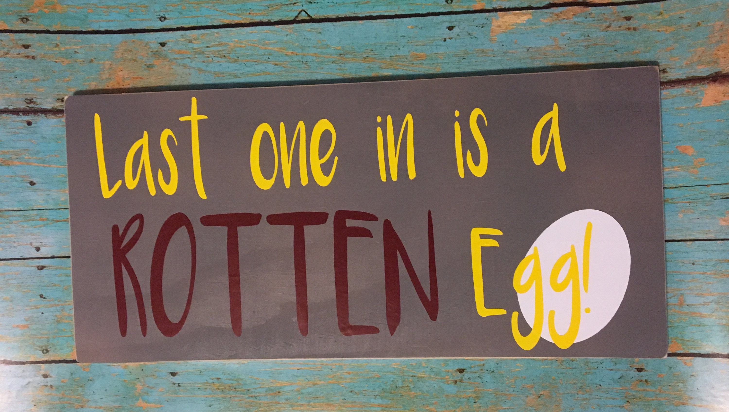 Chicken coop sign. Last one in is a rotten egg.