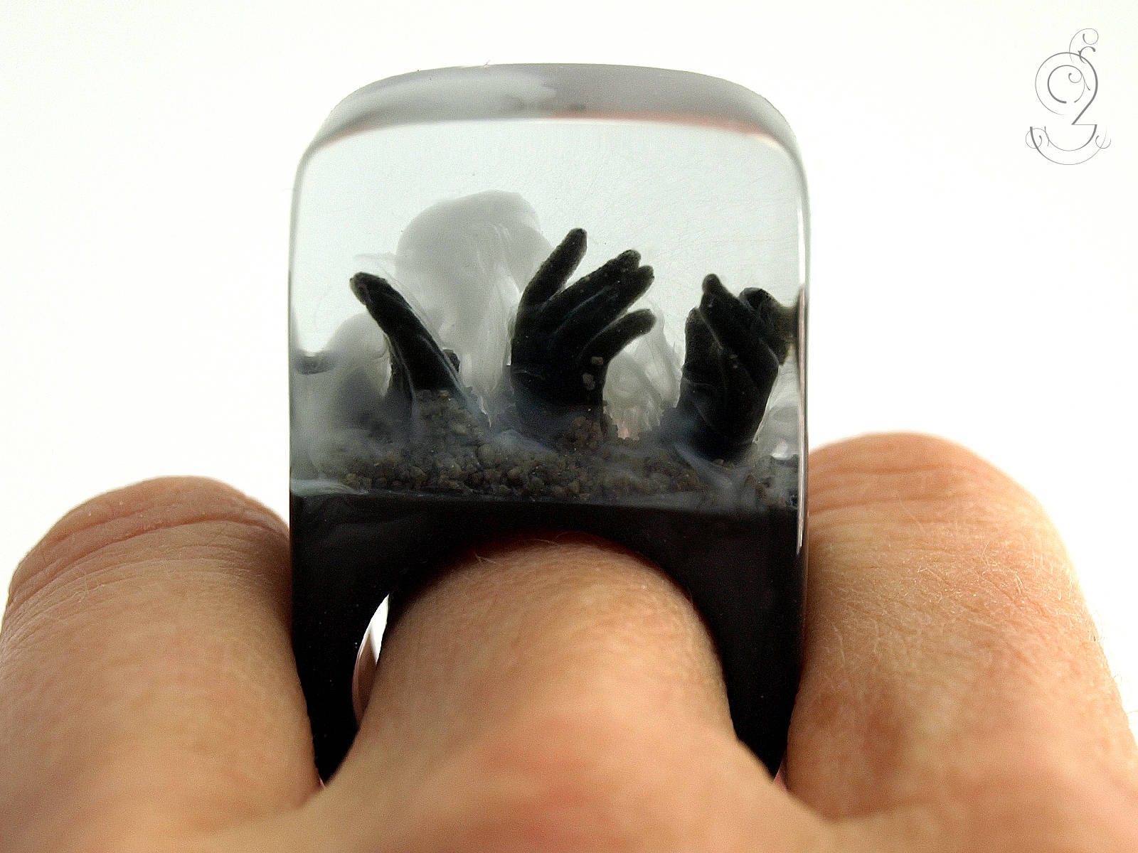 Zombie creepy undead ring with three black hands and fog on